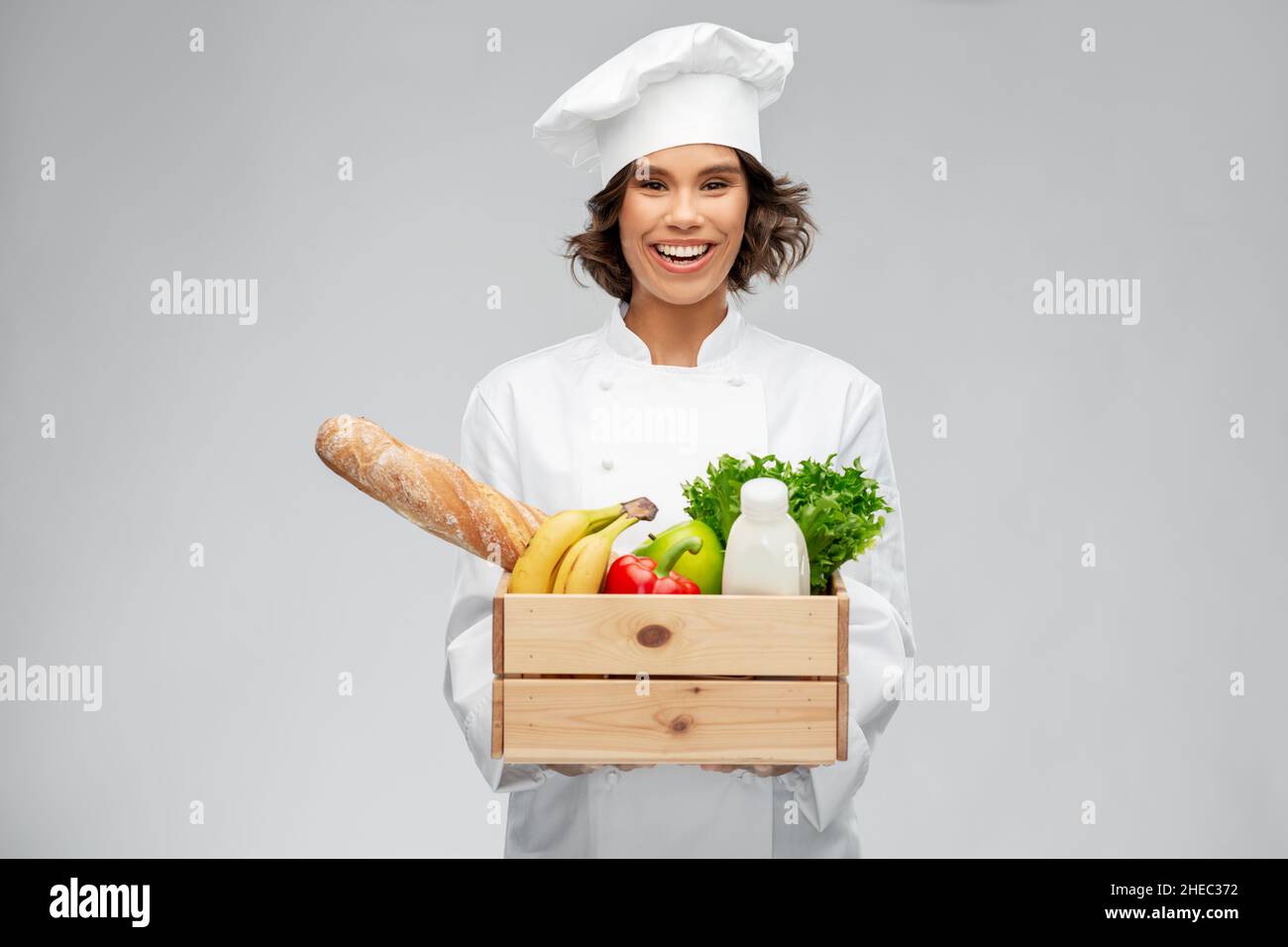 happy smiling female chef with food in wooden box Stock Photo - Alamy