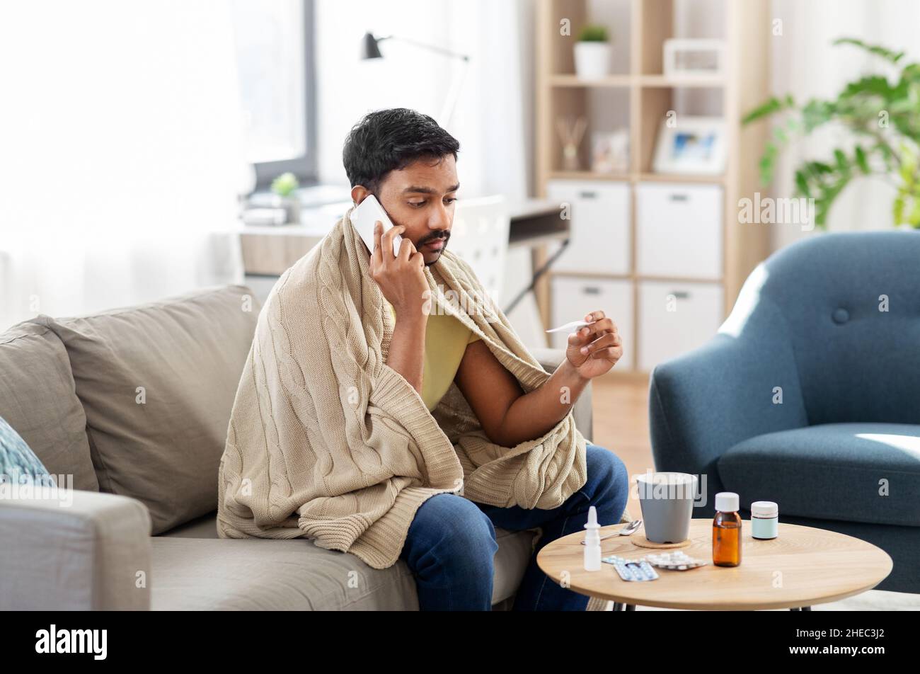 sick man with thermometer calling on smartphone Stock Photo - Alamy