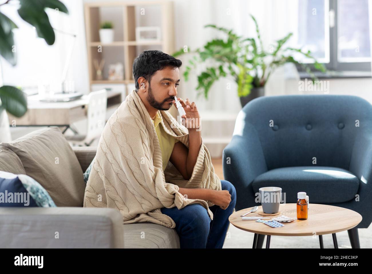sick indian man using nasal spray at home Stock Photo - Alamy
