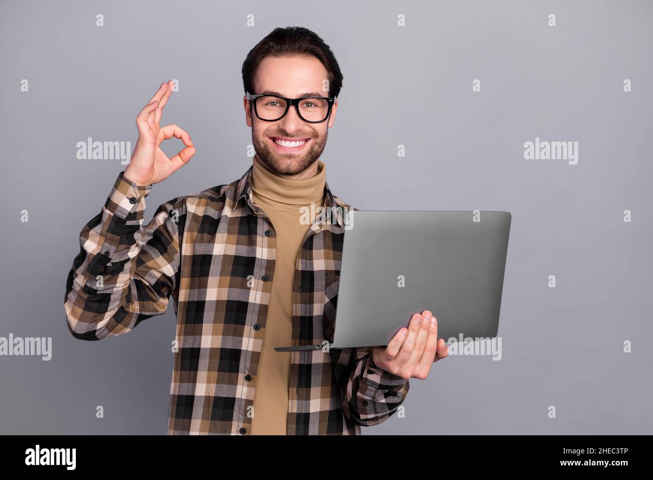 Photo of attractive man wear plaid shirt spectacles showing okey typing ...