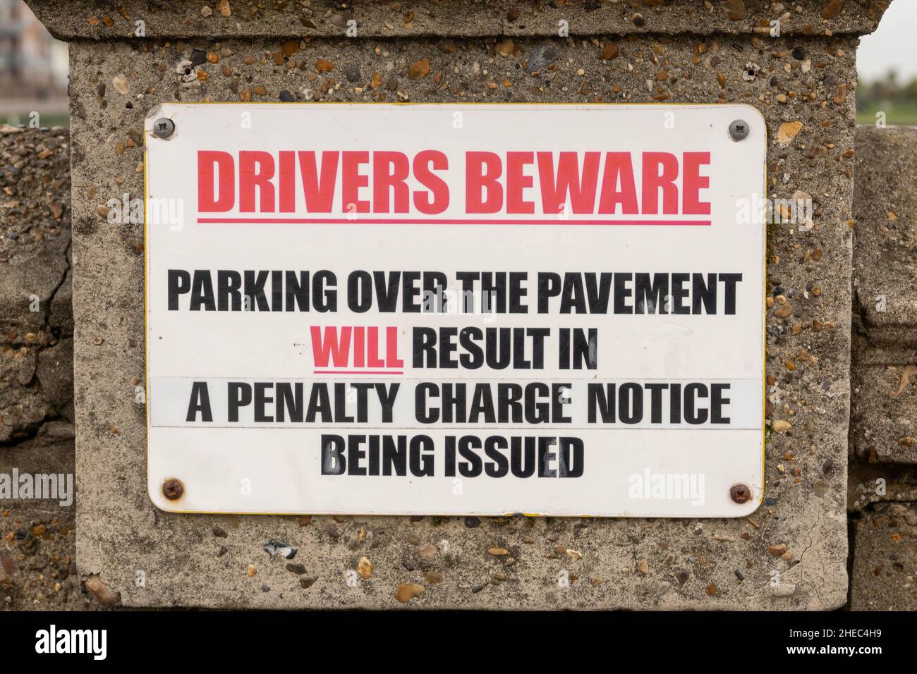 Drivers beware sign screwed to a concrete pillar Stock Photo - Alamy