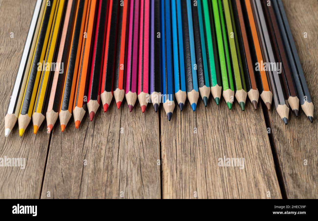 Assorted color pencils over wooden table with copy space Stock Photo ...