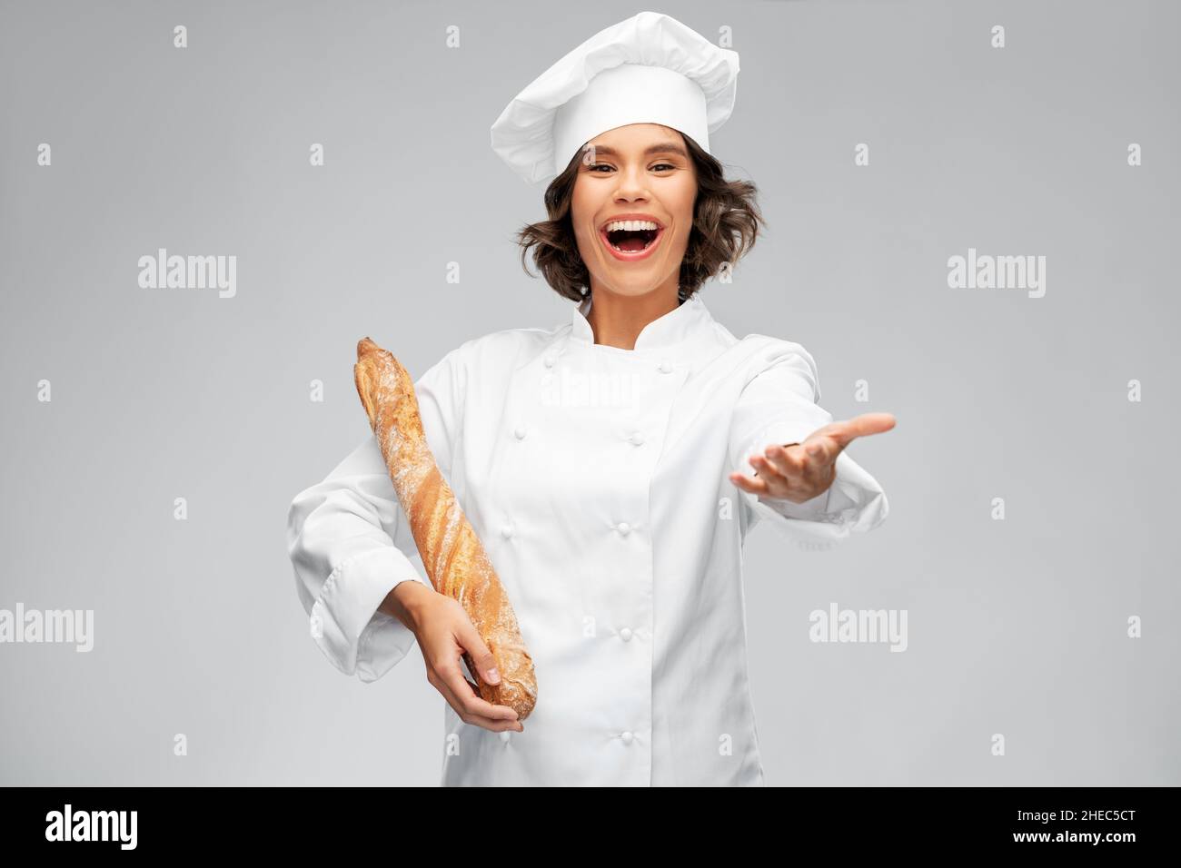happy female chef with french bread or baguette Stock Photo - Alamy
