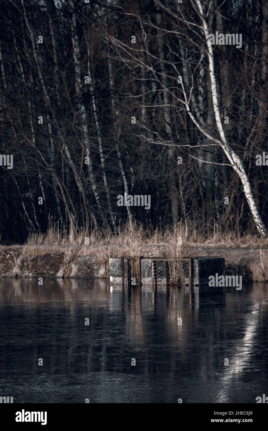 Pond with a well Stock Photo - Alamy