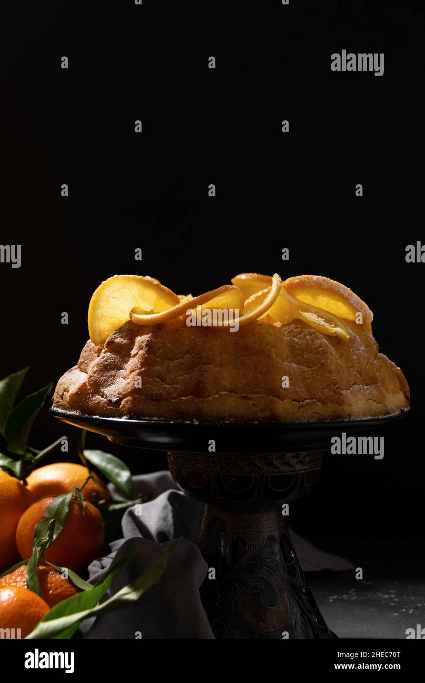 Traditional homemade orange cake, dark background, food themes Stock ...