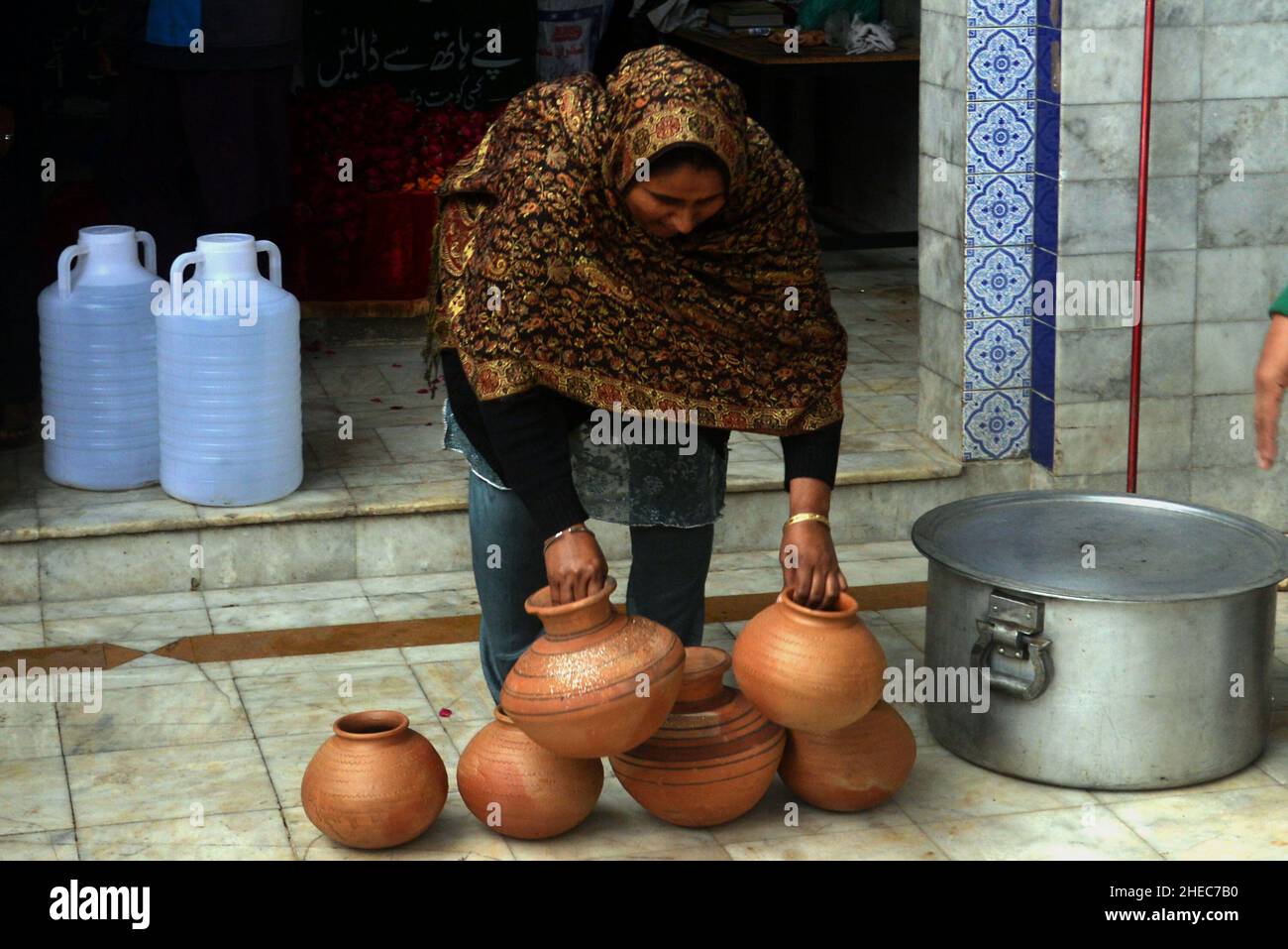 Lahore, Pakistan. 10th Jan, 2022. Pakistani women devotees bringing ...