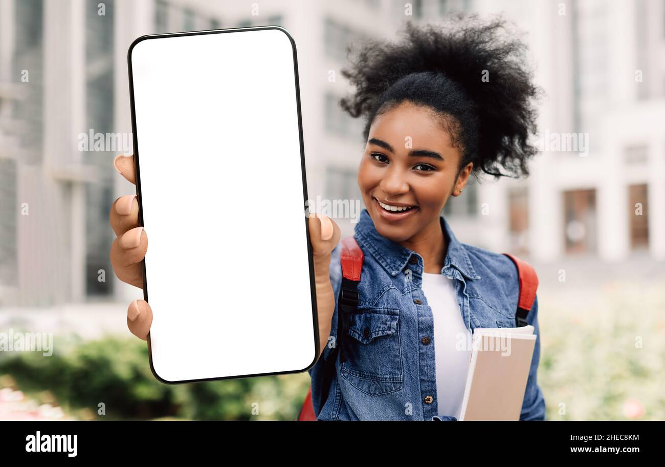 Happy Black Female Student Showing Blank Smartphone While Standing Near University Building ...