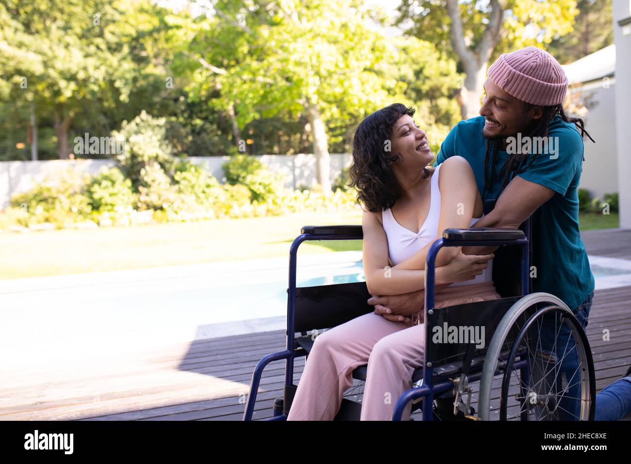 African american man hugging his disabled wife on wheelchair and ...