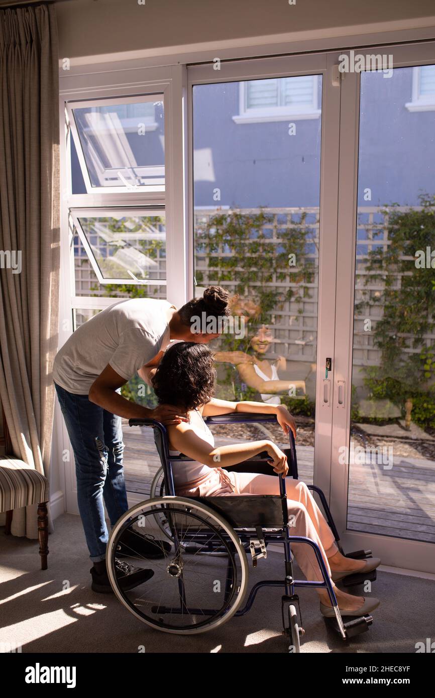 African american disabled woman on a wheelchair and her husband looking ...