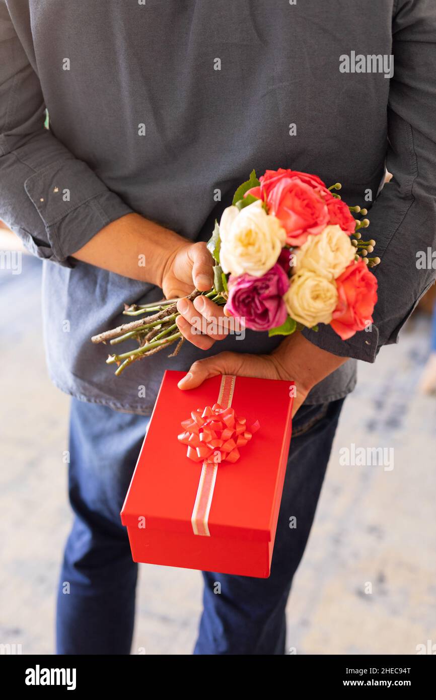 Man hiding gift box behind back hi-res stock photography and images - Alamy
