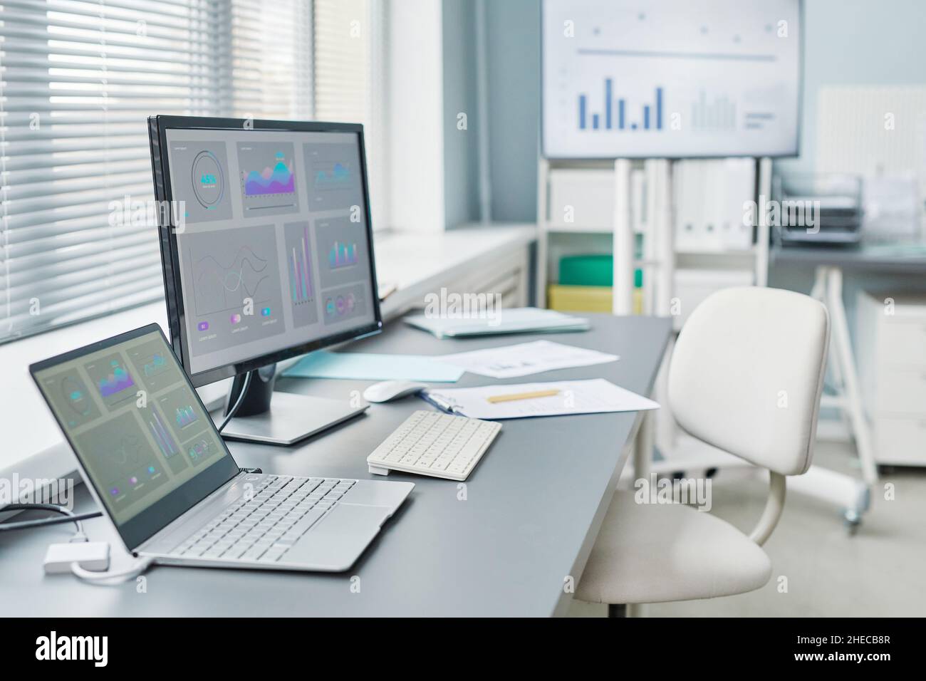 Image of workplace of chemist with laptop and computer with charts on ...