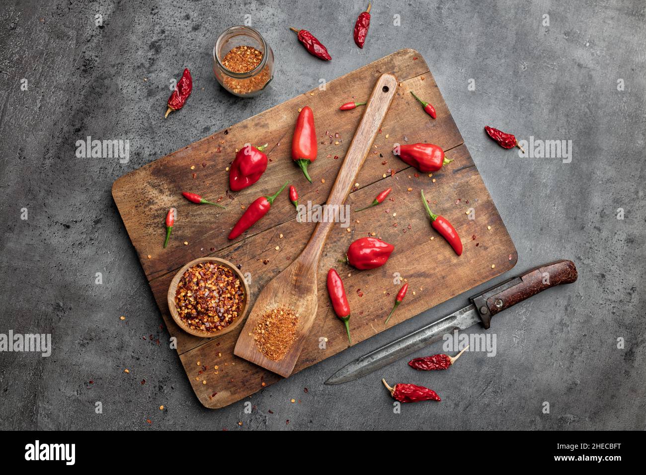 Variety of fresh and dried chili peppers on rustic background Stock ...