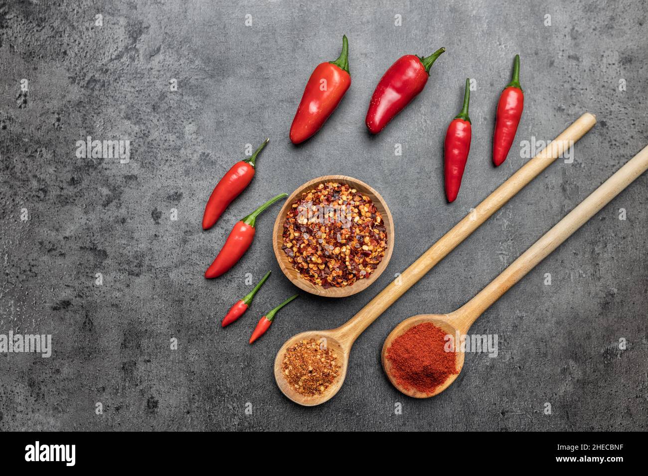 Variety of fresh and dried chili peppers on rustic background Stock ...
