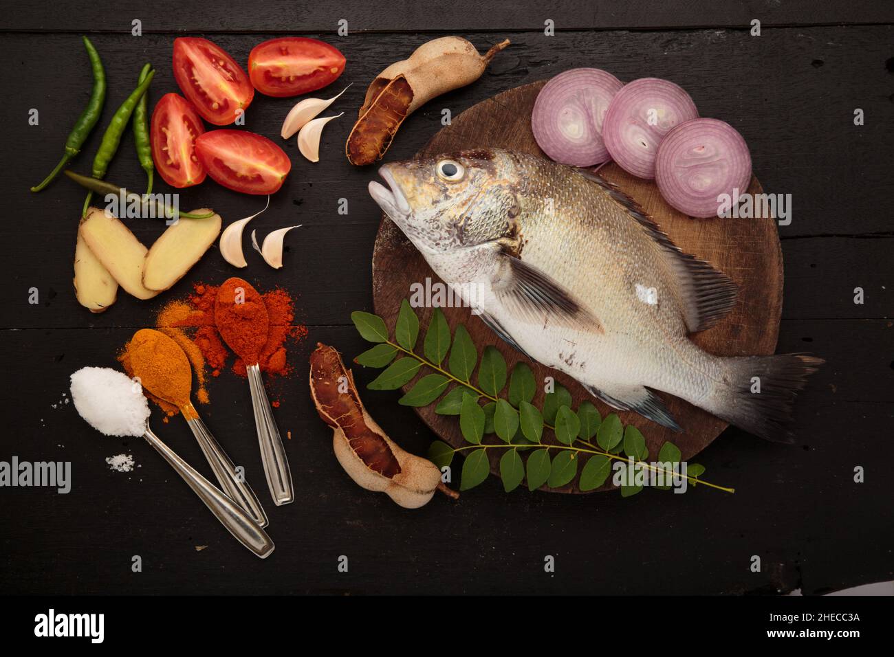 Fresh raw fish and food ingredients, Traditional Kerala style Fish ...