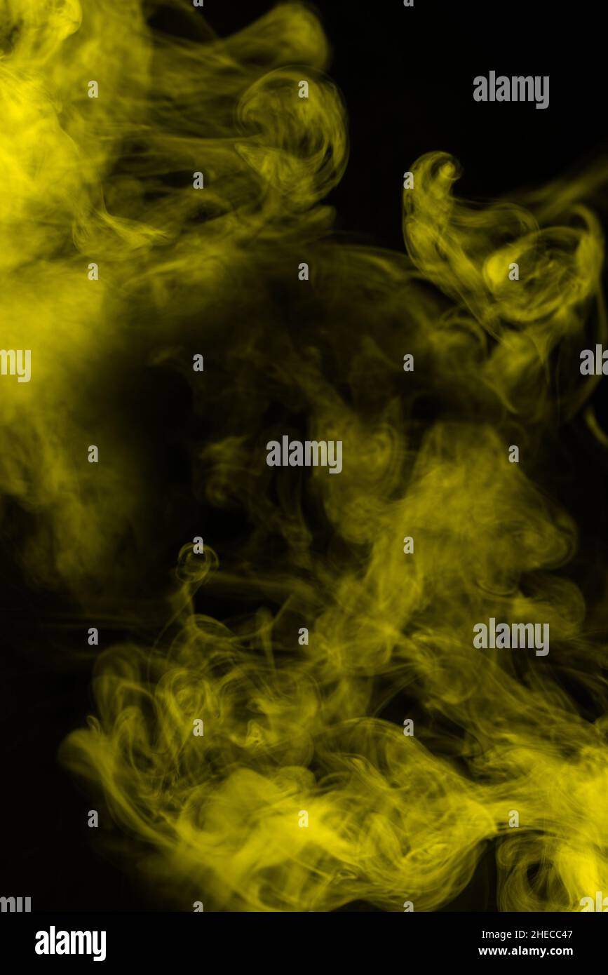Yellow steam on a black background. Copy space Stock Photo - Alamy