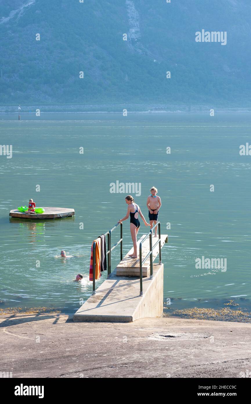Kids having fun, jumping into cold fjord water, Eidfjord, Norway Stock ...