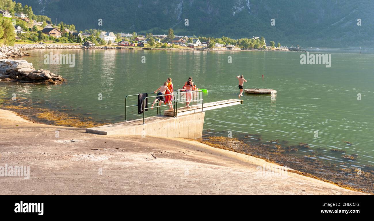 Kids having fun, jumping into cold fjord water, Eidfjord, Norway Stock ...