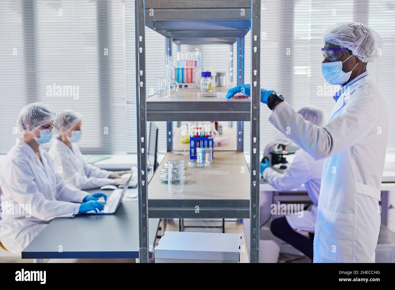 Group doctors working microscope in hi-res stock photography and images ...