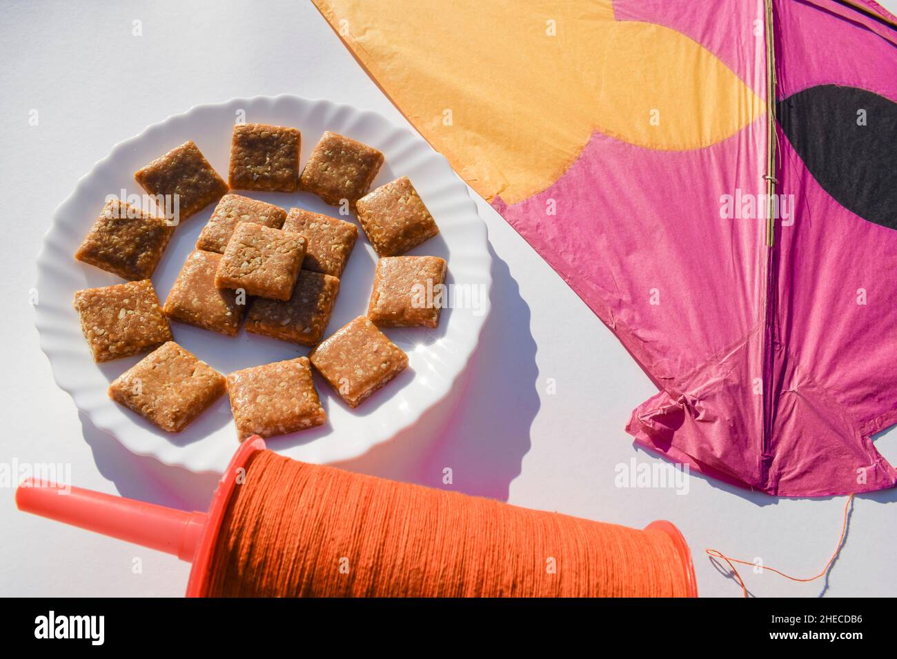 Crushed peanut chikki bars with Kite and spool string with white ...