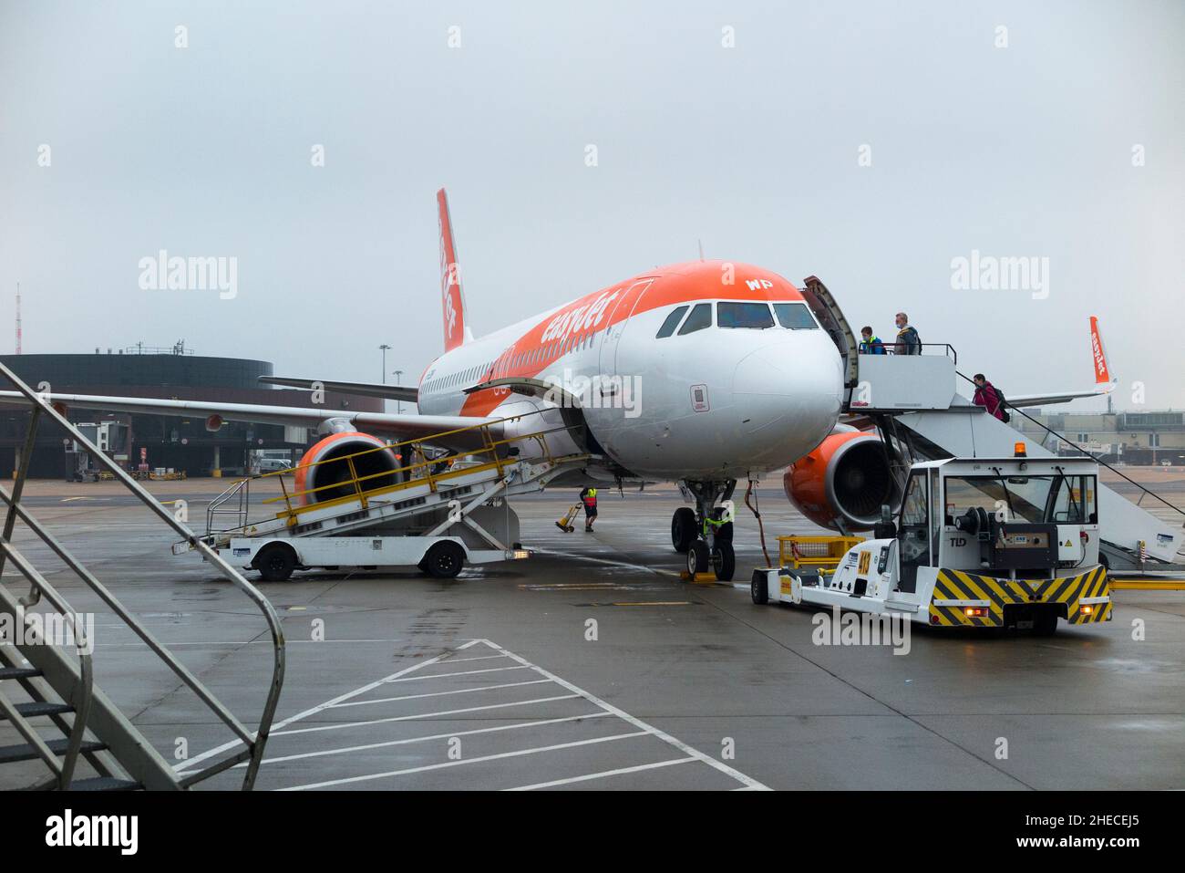 Passengers board / boarding Airbus A320-214 plane aircraft number G ...