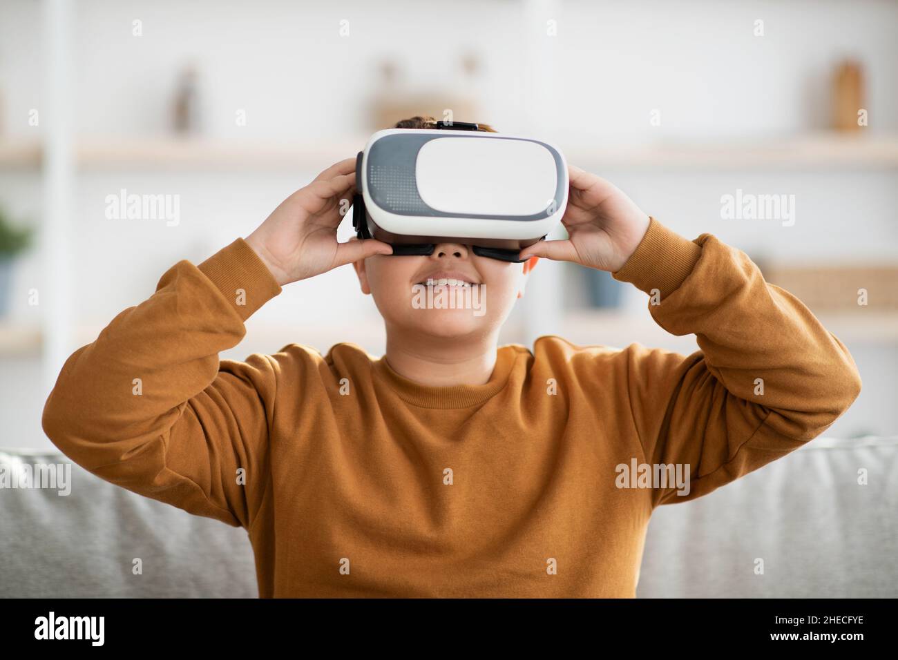 Happy overweight boy with VR glasses, home interior Stock Photo - Alamy