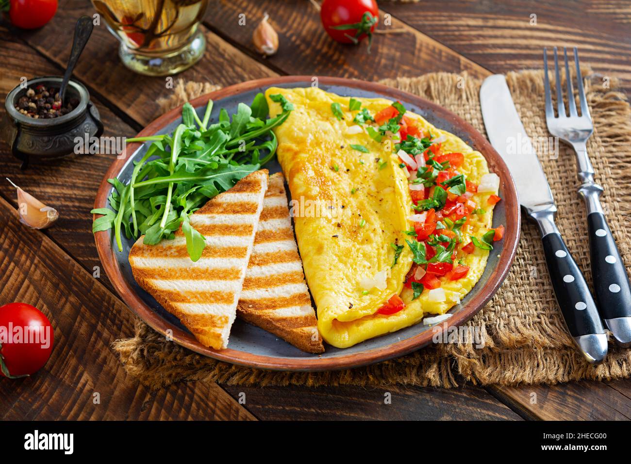 Fried omelette with tomatoes, onion and herbs. Delicious breakfast with ...