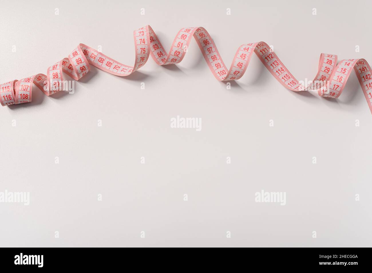 New measuring tape for tailoring on a white background Stock Photo - Alamy