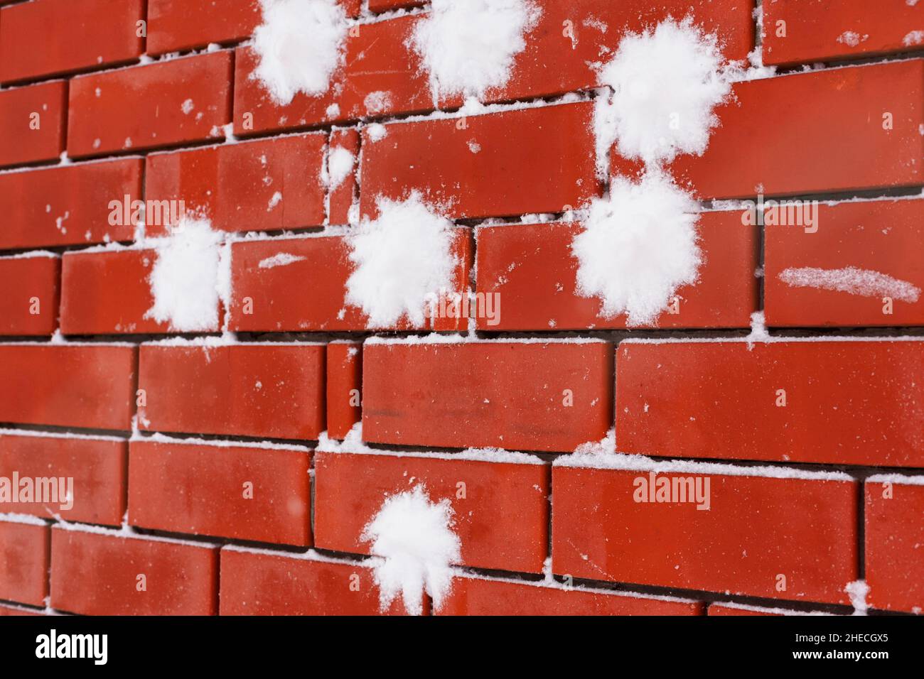 A Brick wall with some snowballs on it. Winter time Stock Photo - Alamy