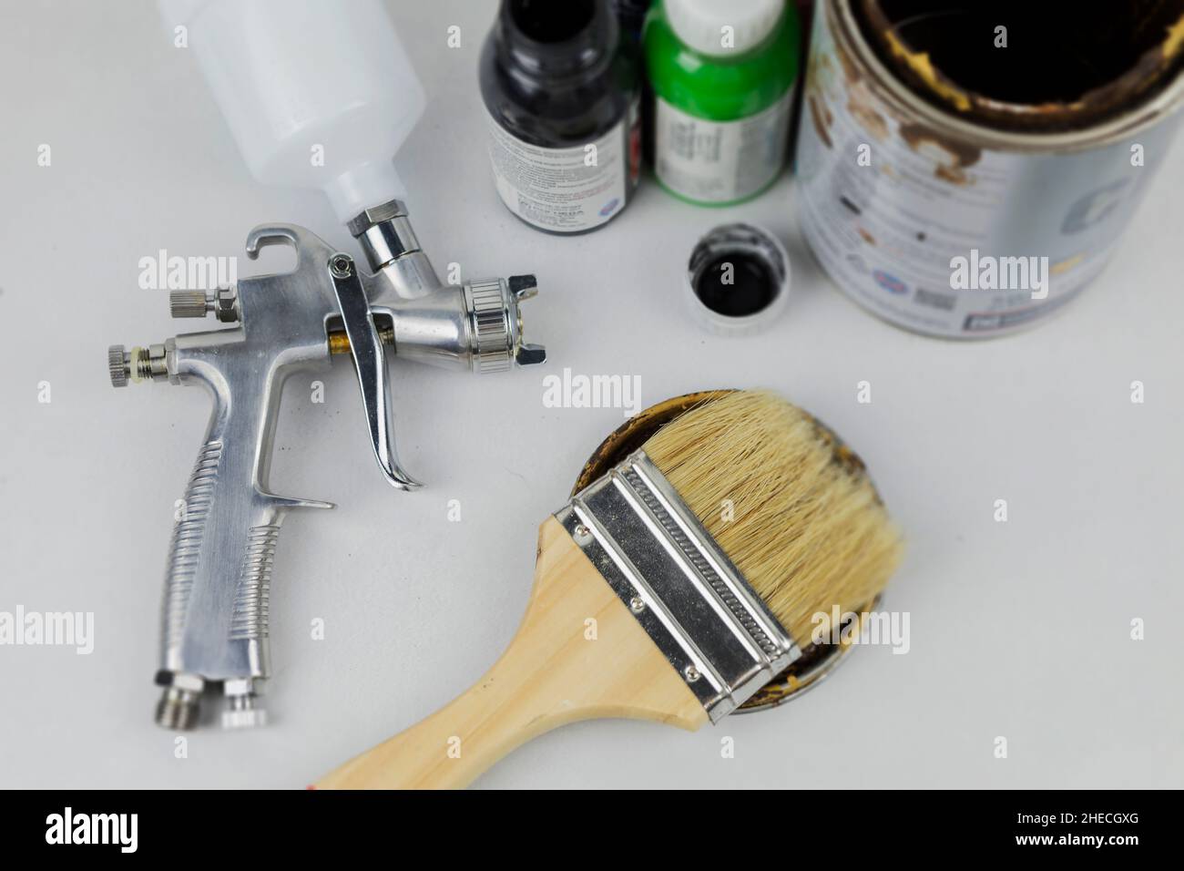 Instructions and a paint spray gun at work at the workplace in the ...