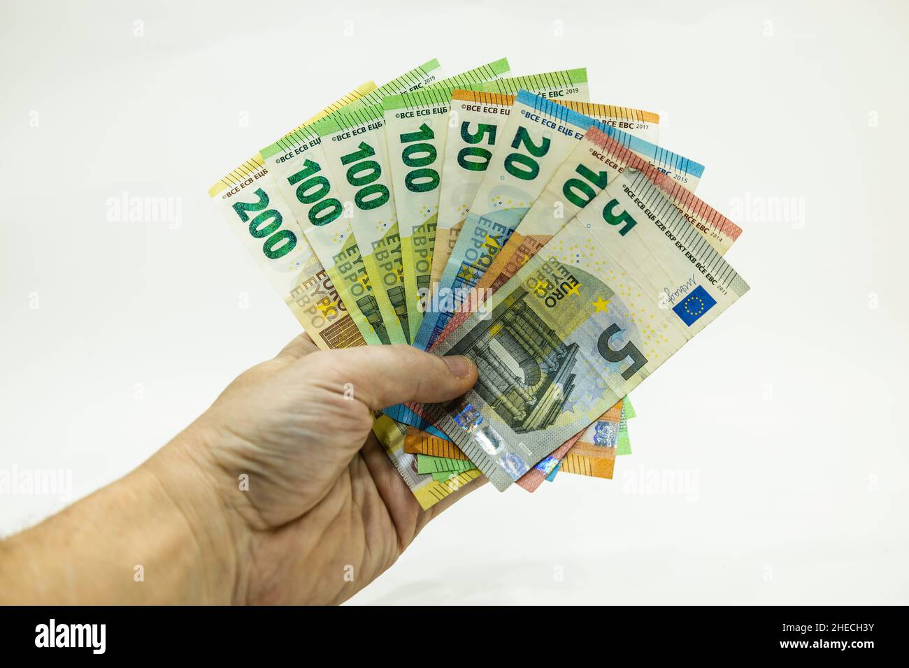 hand holding euro money banknotes on white background Stock Photo - Alamy