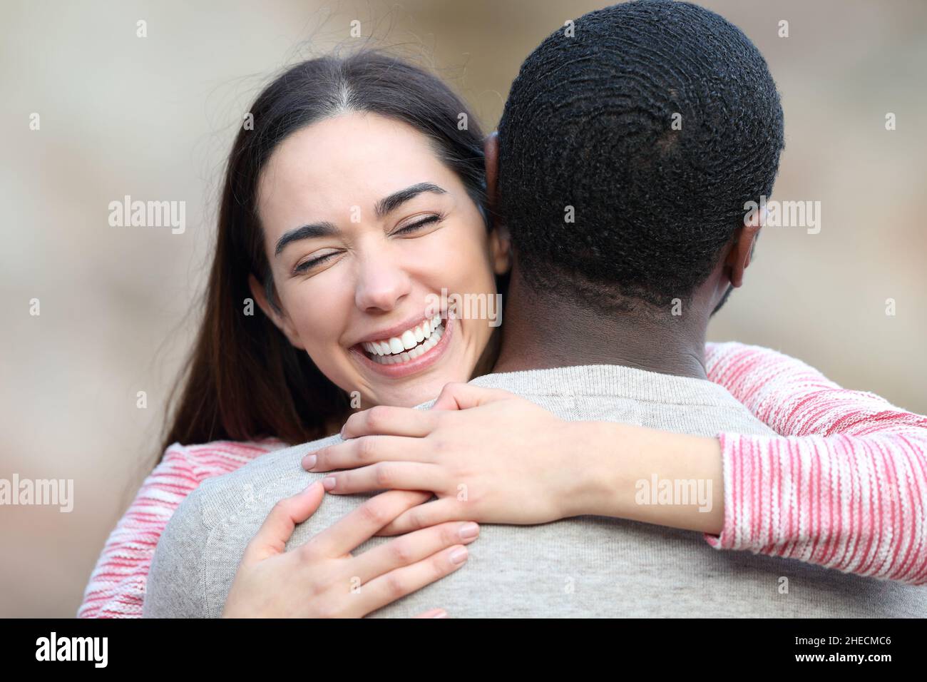 Happy caucasian woman hugging her friend with black skin Stock Photo ...