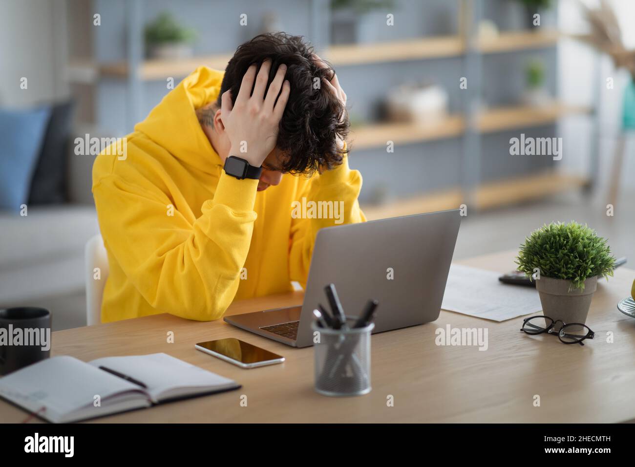 Stressed asian man sitting home hi-res stock photography and images - Alamy