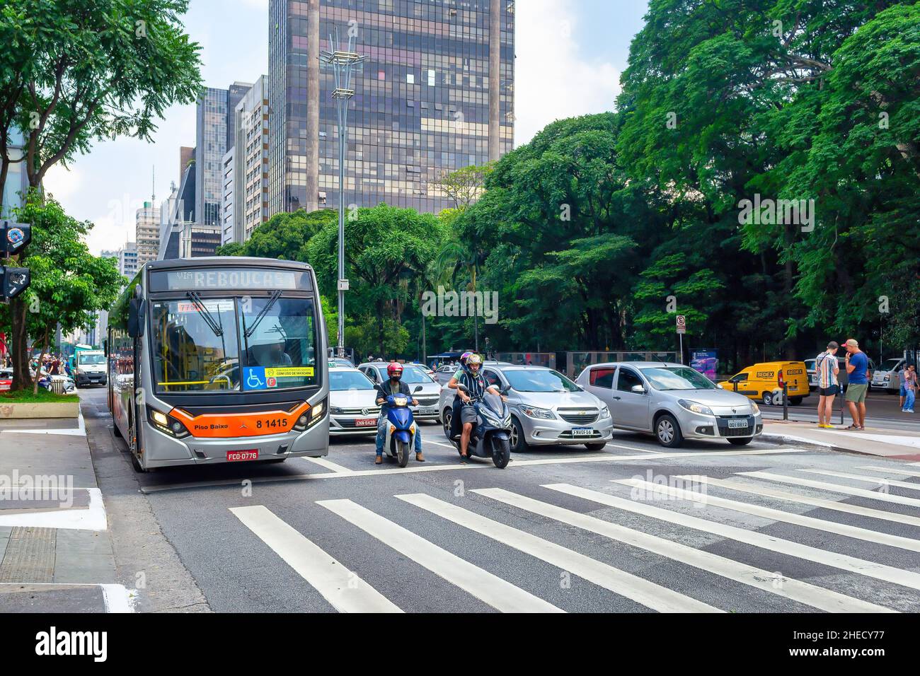 Public transportation bus and other vehicles at a light stop in the ...
