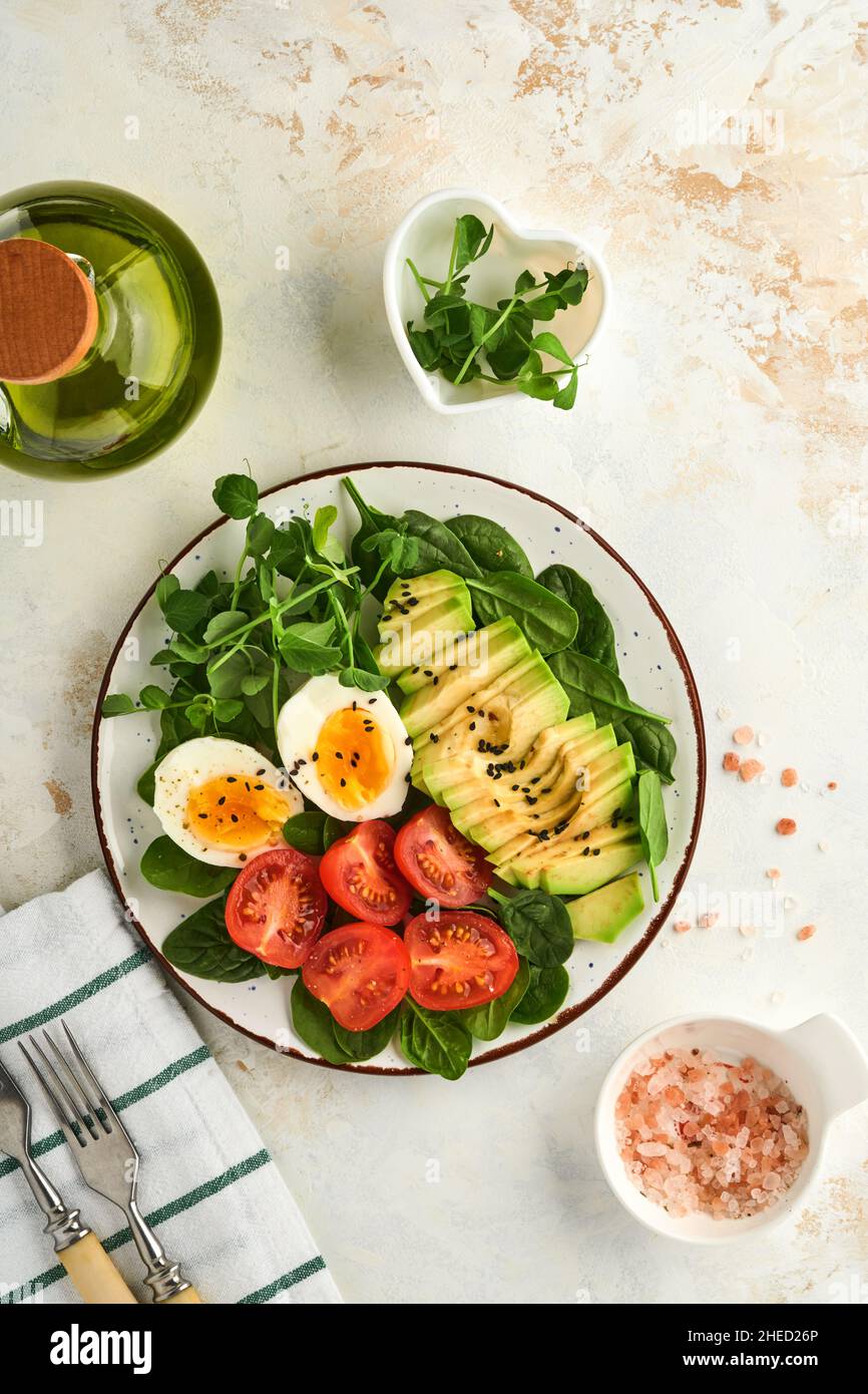 Avocado, cherry tomato, spinach and chicken egg, microgreens peas and ...