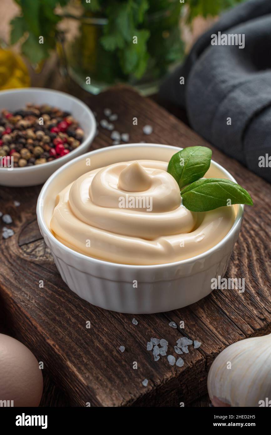 Fresh mayonnaise close-up on the background of spices. Side view, close ...