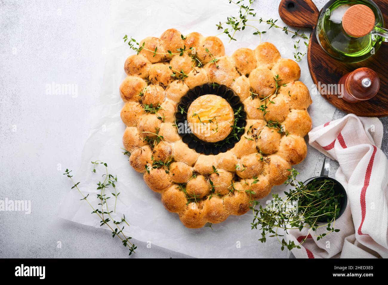 Roasted camembert cheese and homemade bread heart shaped and thyme on ...