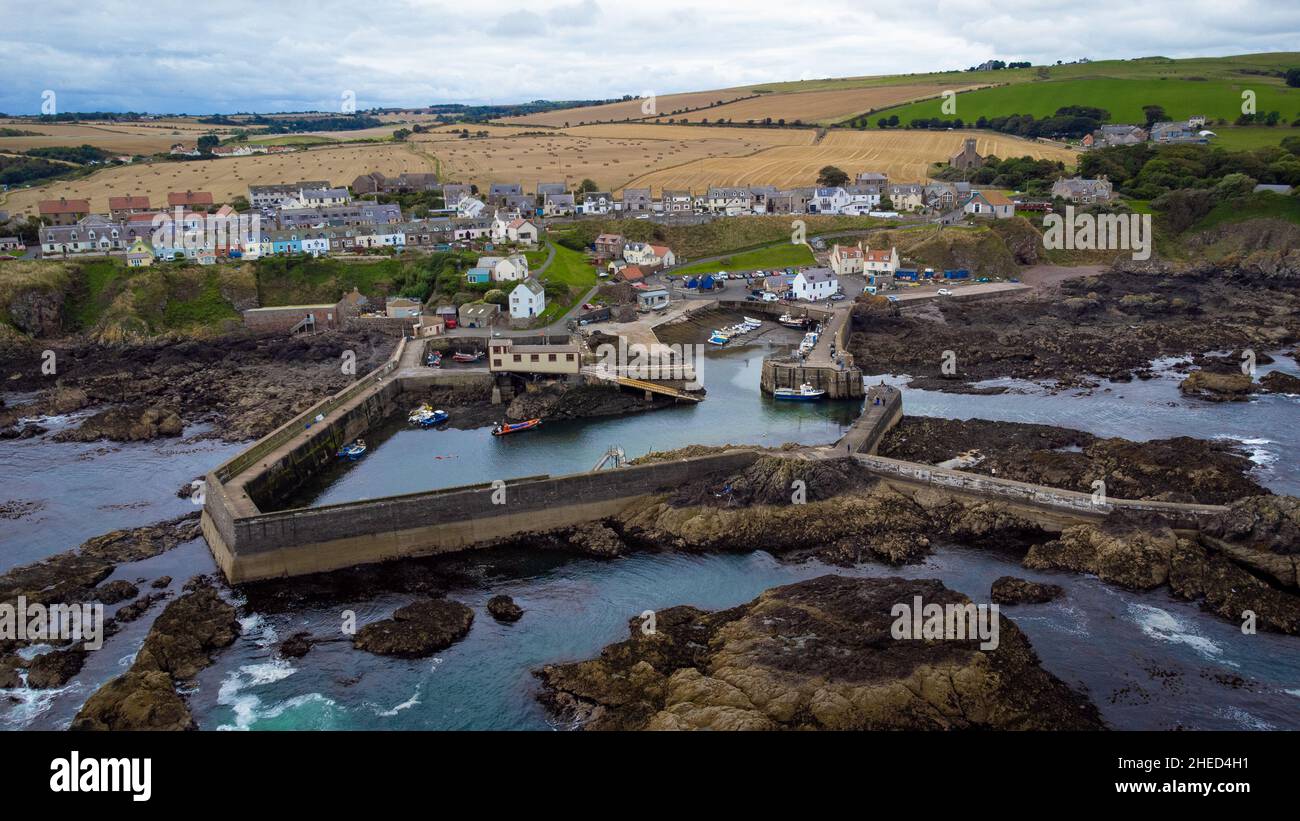 Seaside harbour with blue water from the air Stock Photo - Alamy