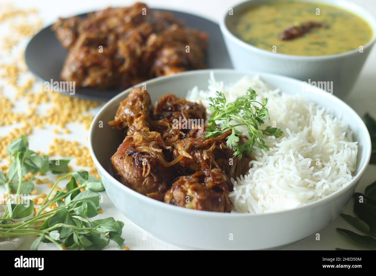 Kerala style dry chicken roast and lentil curry prepared with fenugreek ...