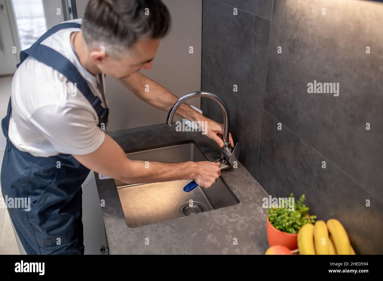 Man turning tap hi-res stock photography and images - Alamy