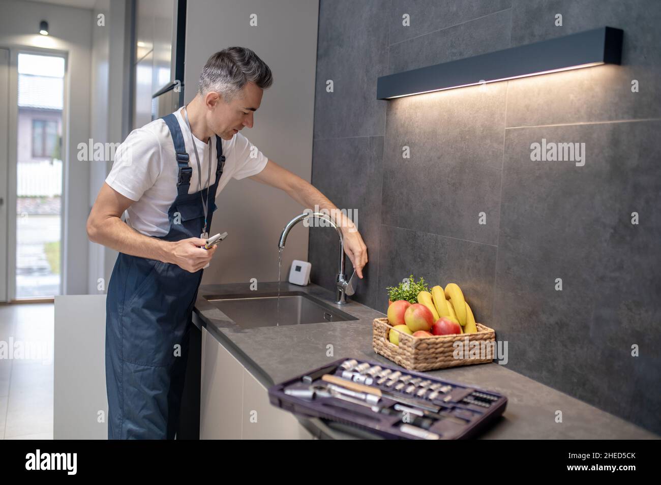 Man opening tap hi-res stock photography and images - Alamy