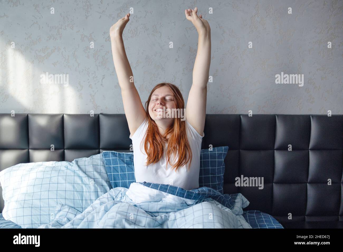 Beautiful happy woman stretching morning wake up bedroom. Lifestyle ...