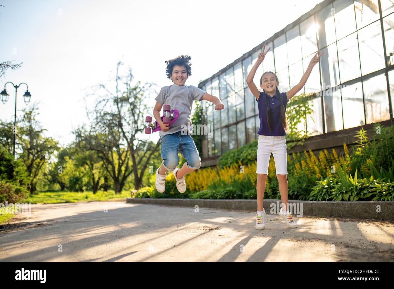 Two children having fun in a local park Stock Photo - Alamy
