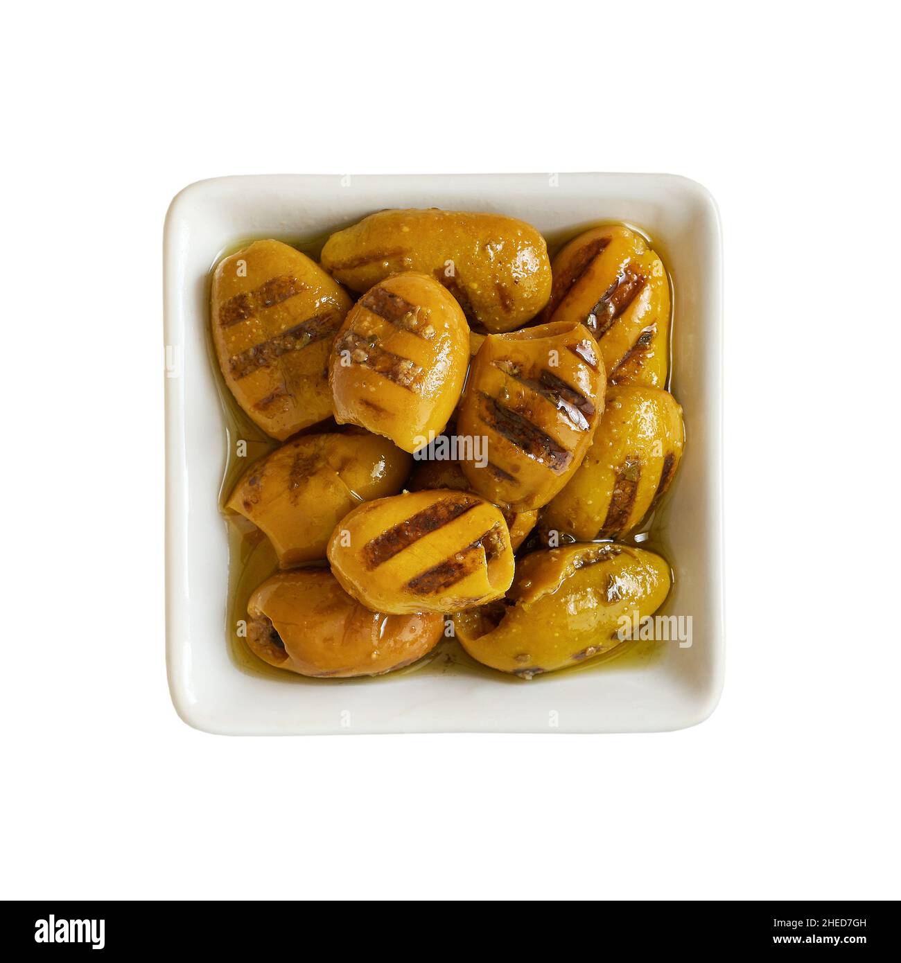 Top view on grilled olives barbecued in olive oil with garlic in a ...