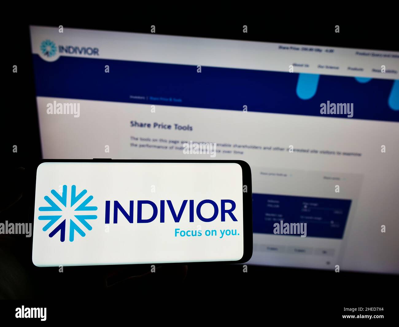 Person holding smartphone with logo of British pharmaceutical company ...