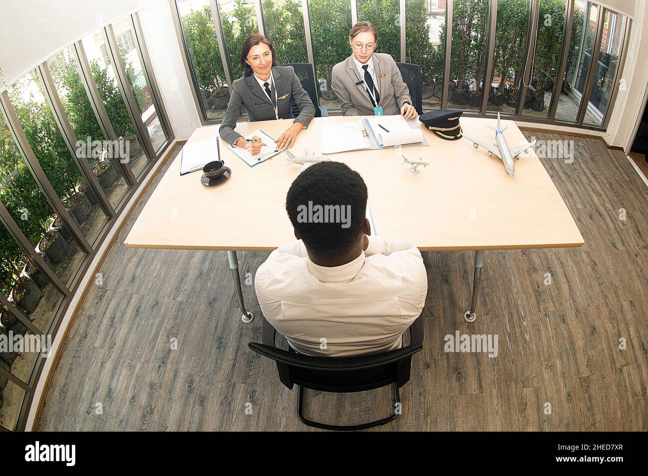 Aviation worker interviewing male job applicants At work on the ground ...