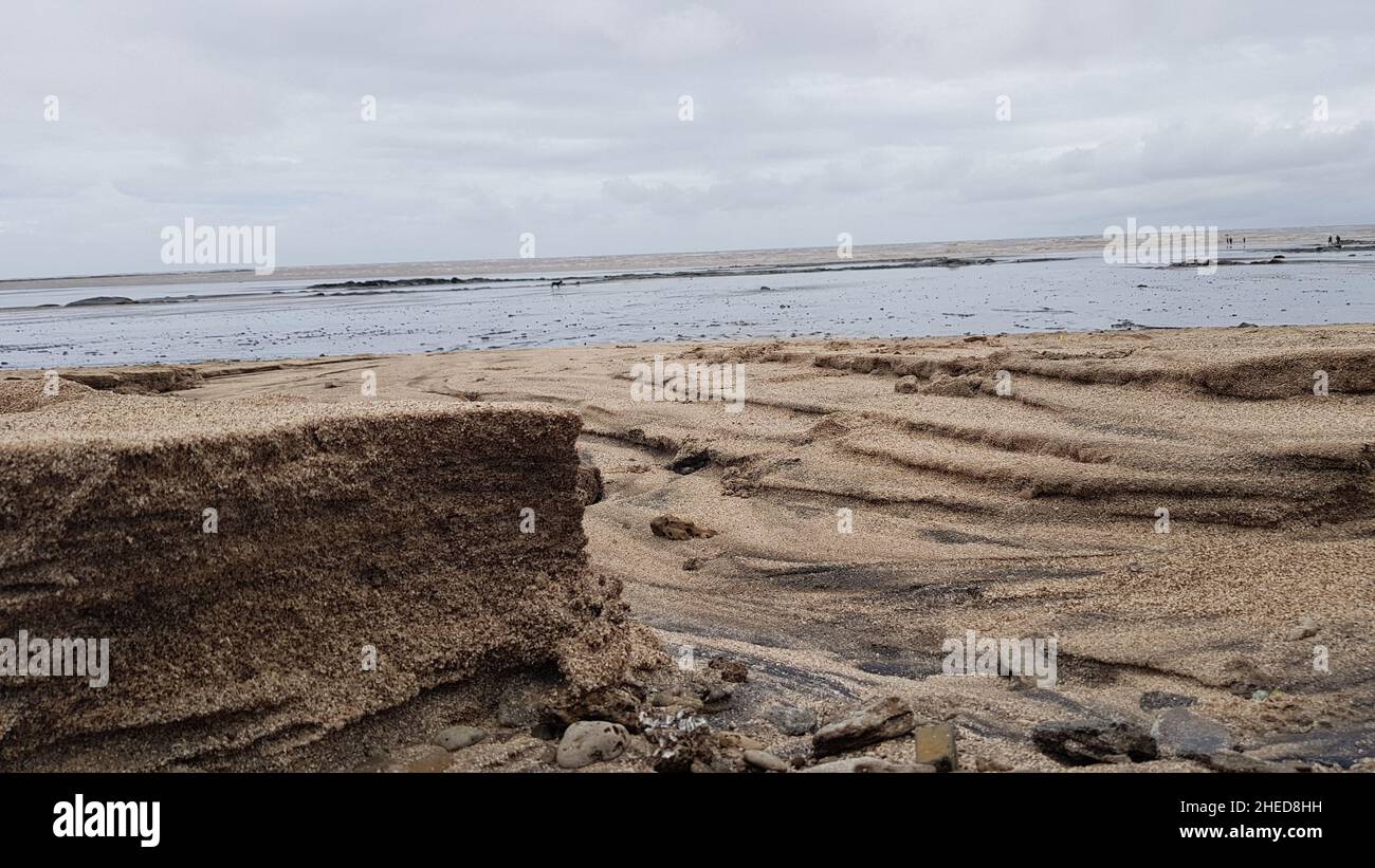 Small sand walls created due to soil erosion by streams of rain water ...