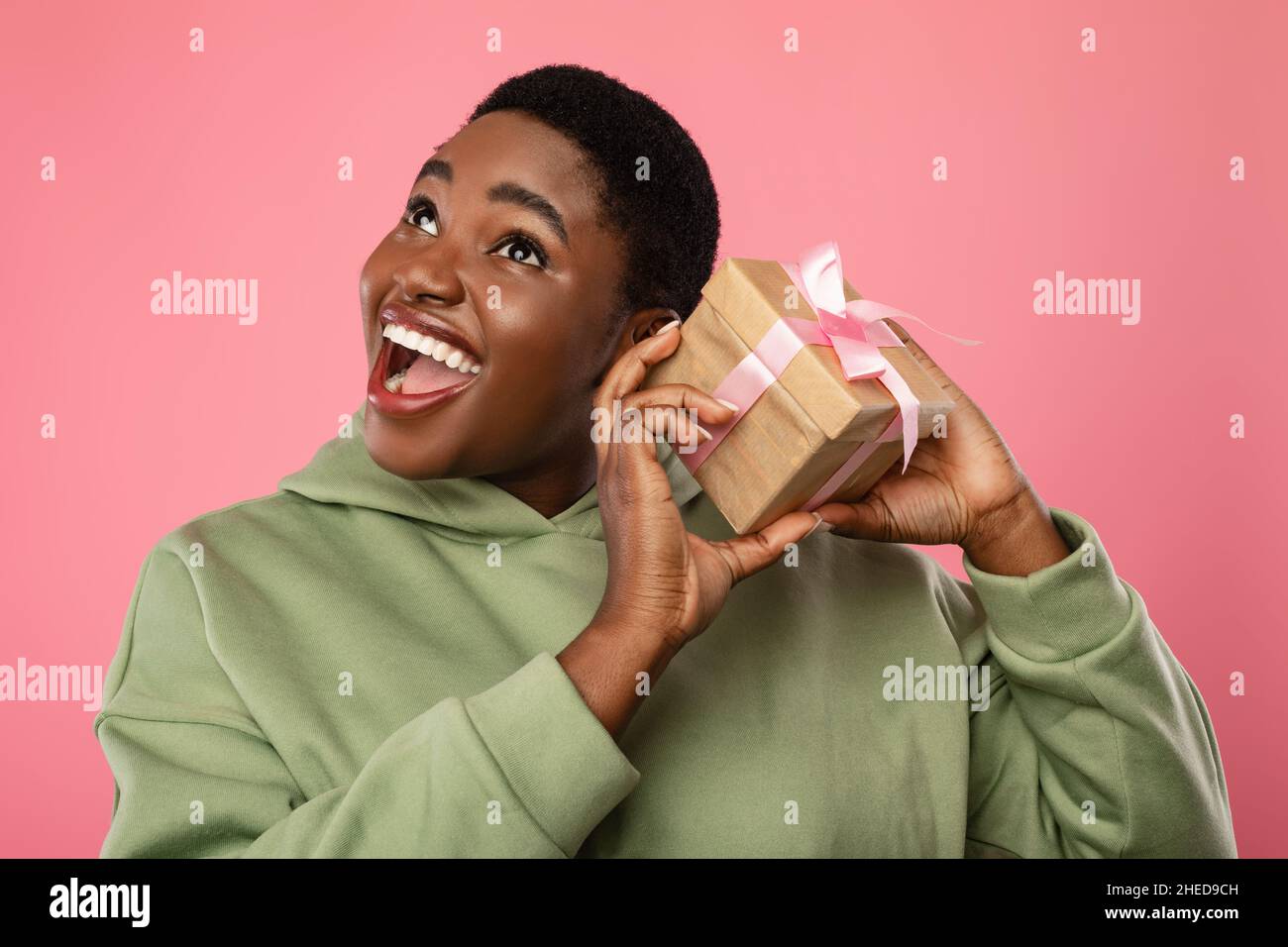 Woman shaking gift box hi-res stock photography and images - Alamy