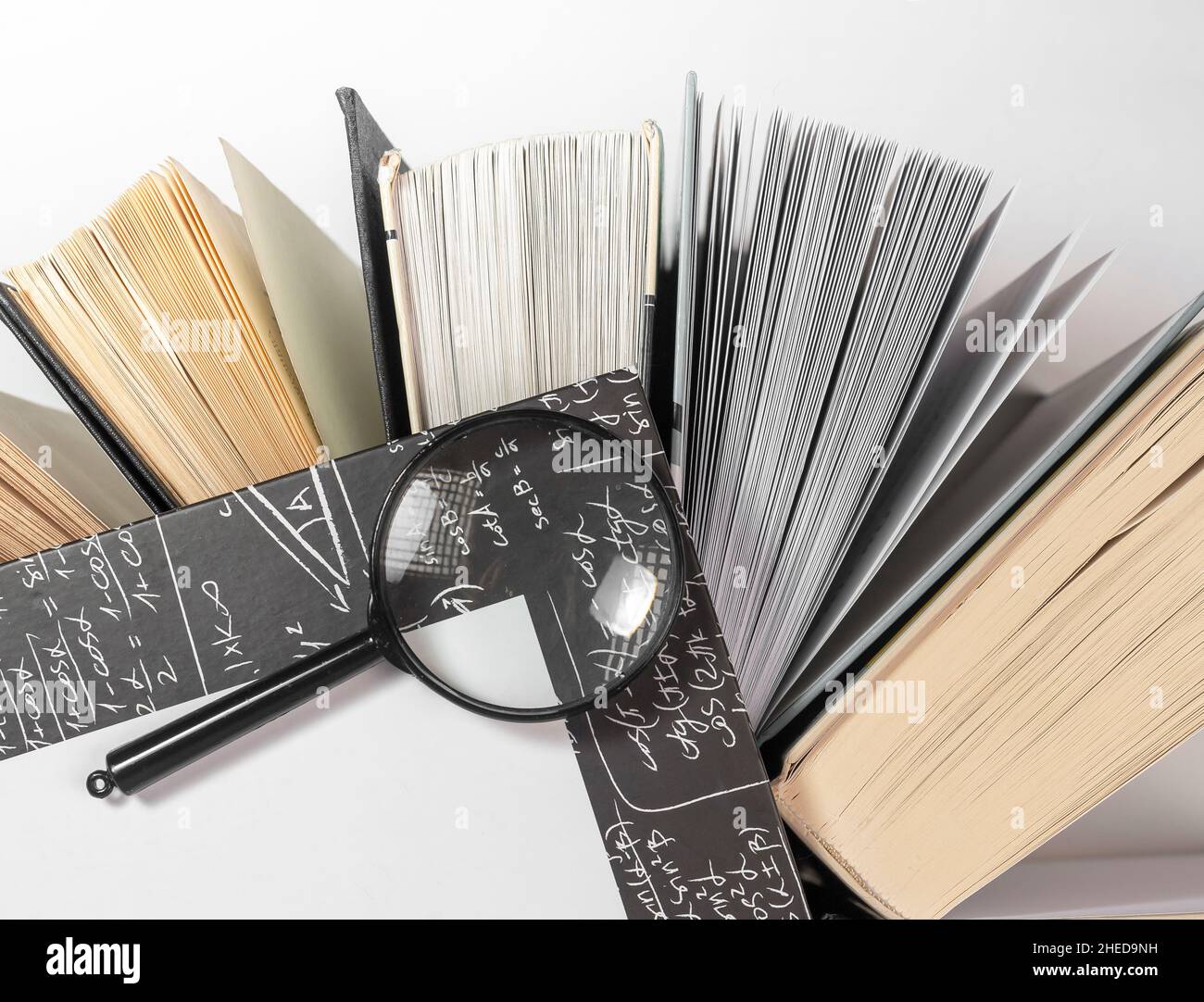 Magnifying lens over books with lot of pages. Concept of knowledge ...