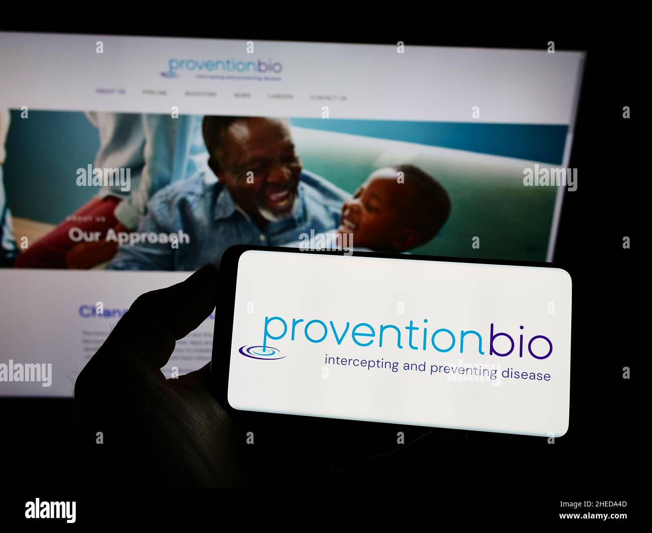 Person holding smartphone with logo of US pharmaceutical company ...