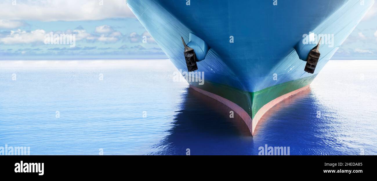 Front view of large blue merchant cargo ship in the middle of the ocean ...